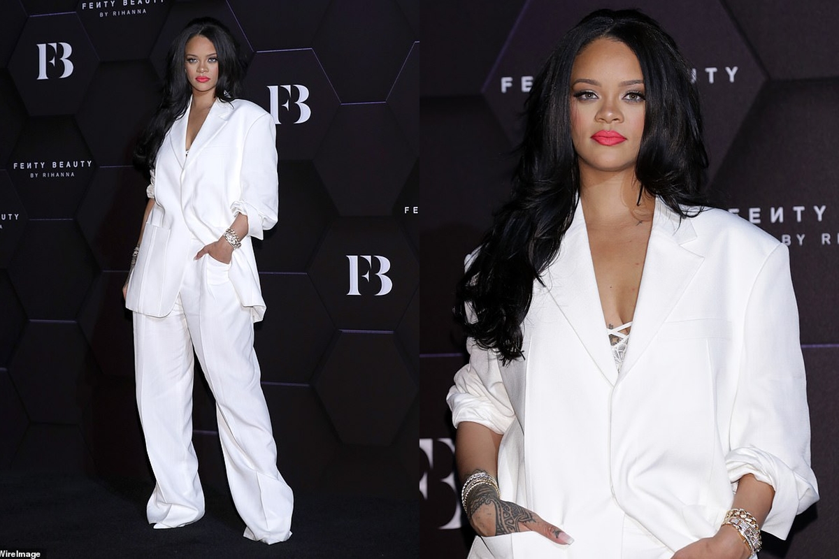 Rihanna cuts a chic figure in an oversized white trouser suit as she ...